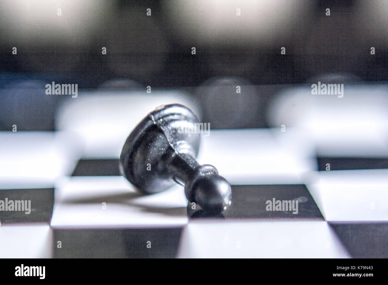 Black pawn soldier down on the chess board Stock Photo - Alamy