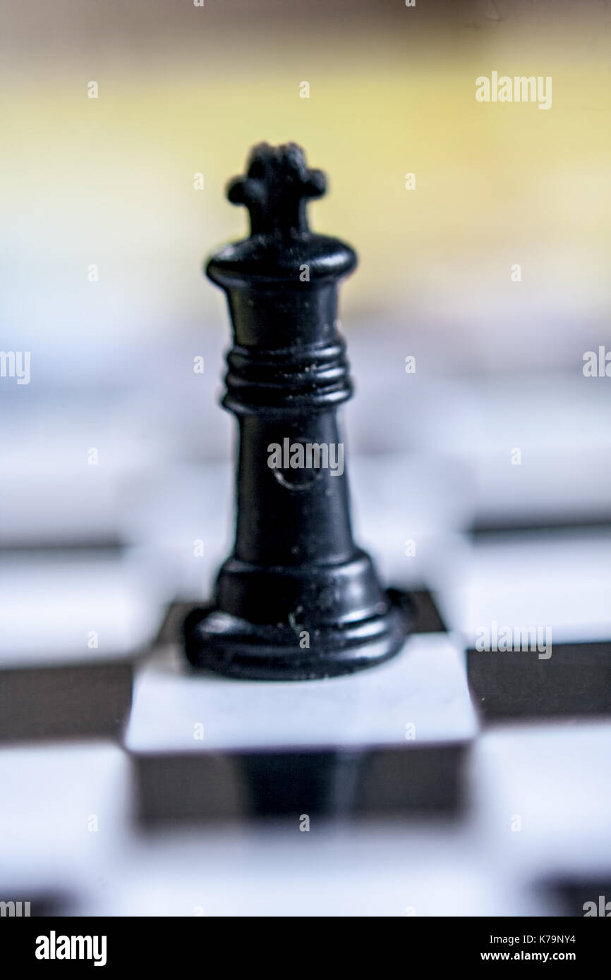 Black queen down on the chess board Stock Photo - Alamy