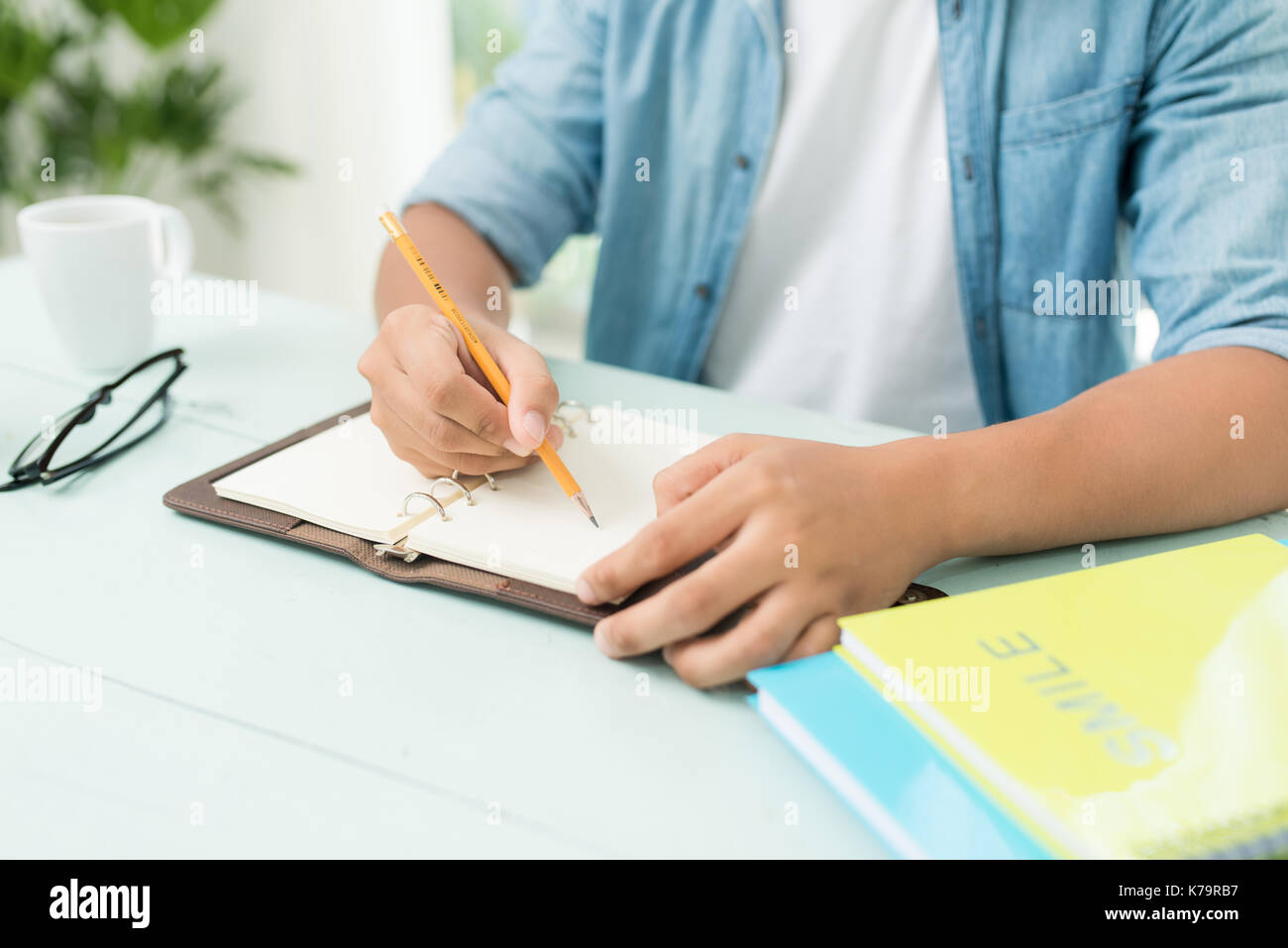 Student doing homework and preparing exam at home Stock Photo - Alamy