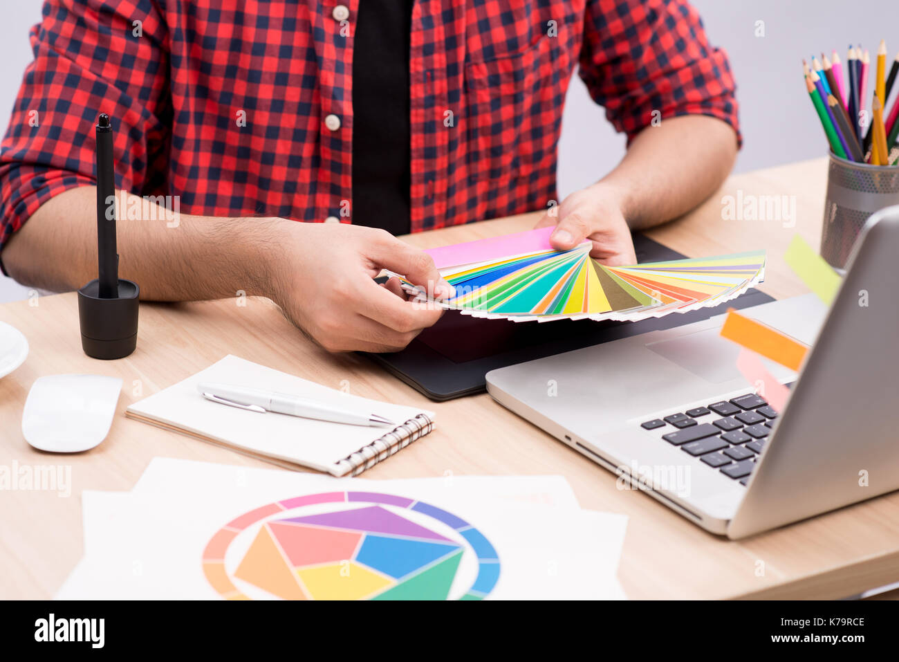 Happy designer working on his laptop in creative office Stock Photo - Alamy