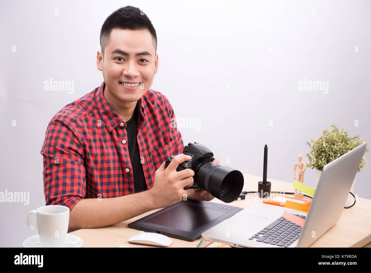 Professional photographer. Portrait of confident young man in shirt ...