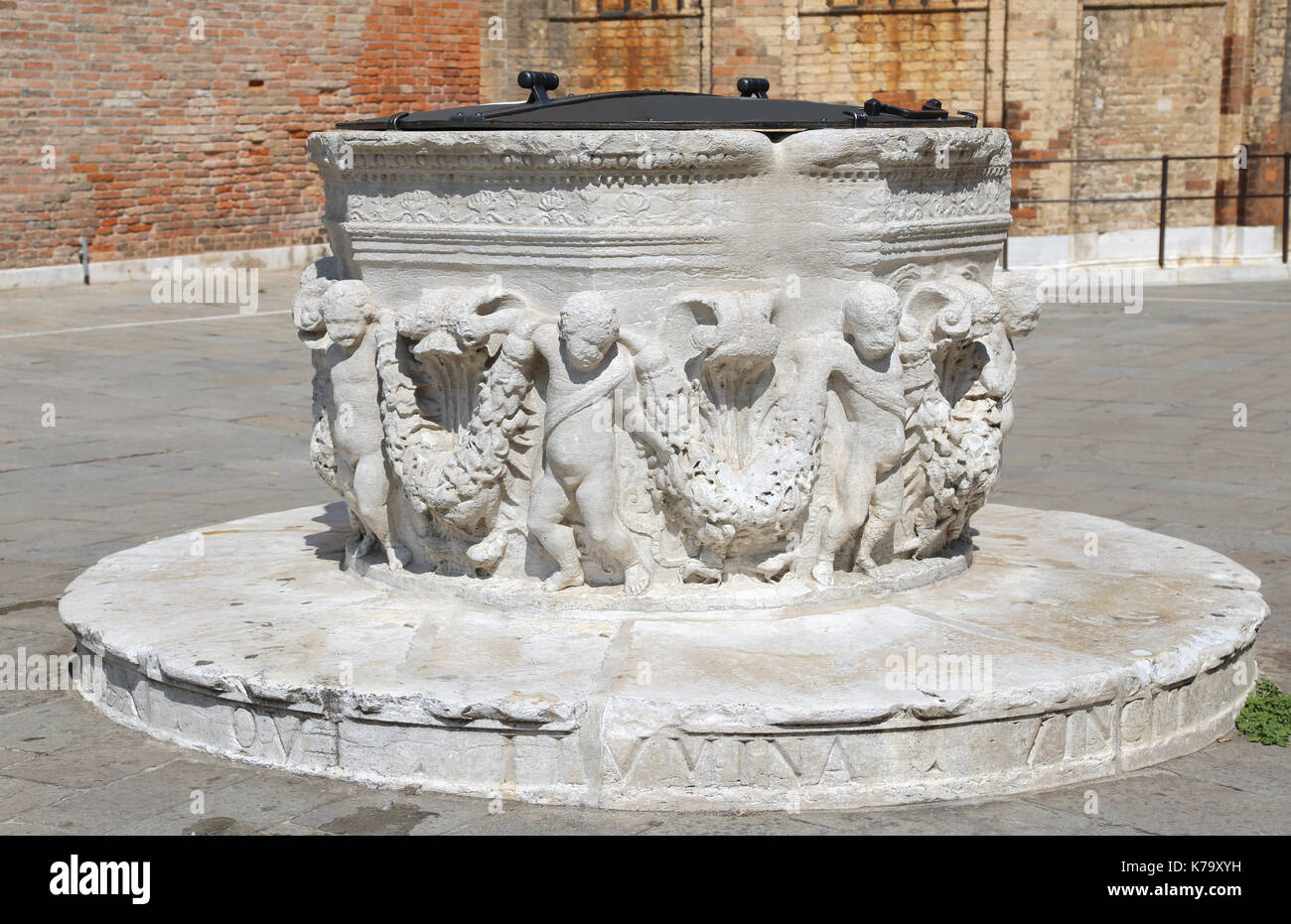 very ancient stone well in a square of a European city Stock Photo - Alamy