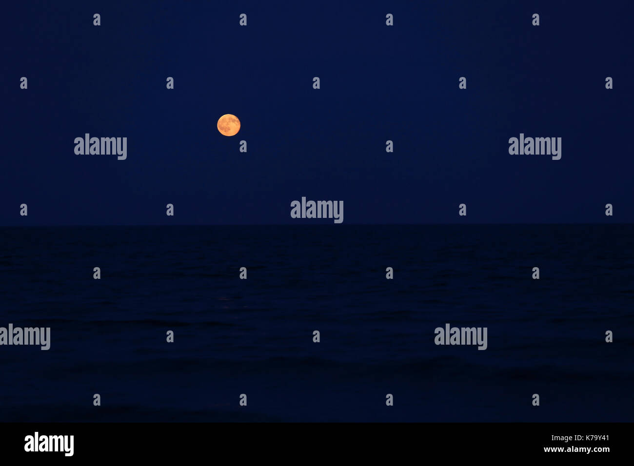 Big red full moon on the horizon over the sea in the evening Stock ...