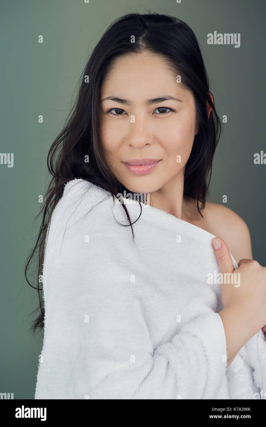Woman wrapped in towel, portrait Stock Photo - Alamy