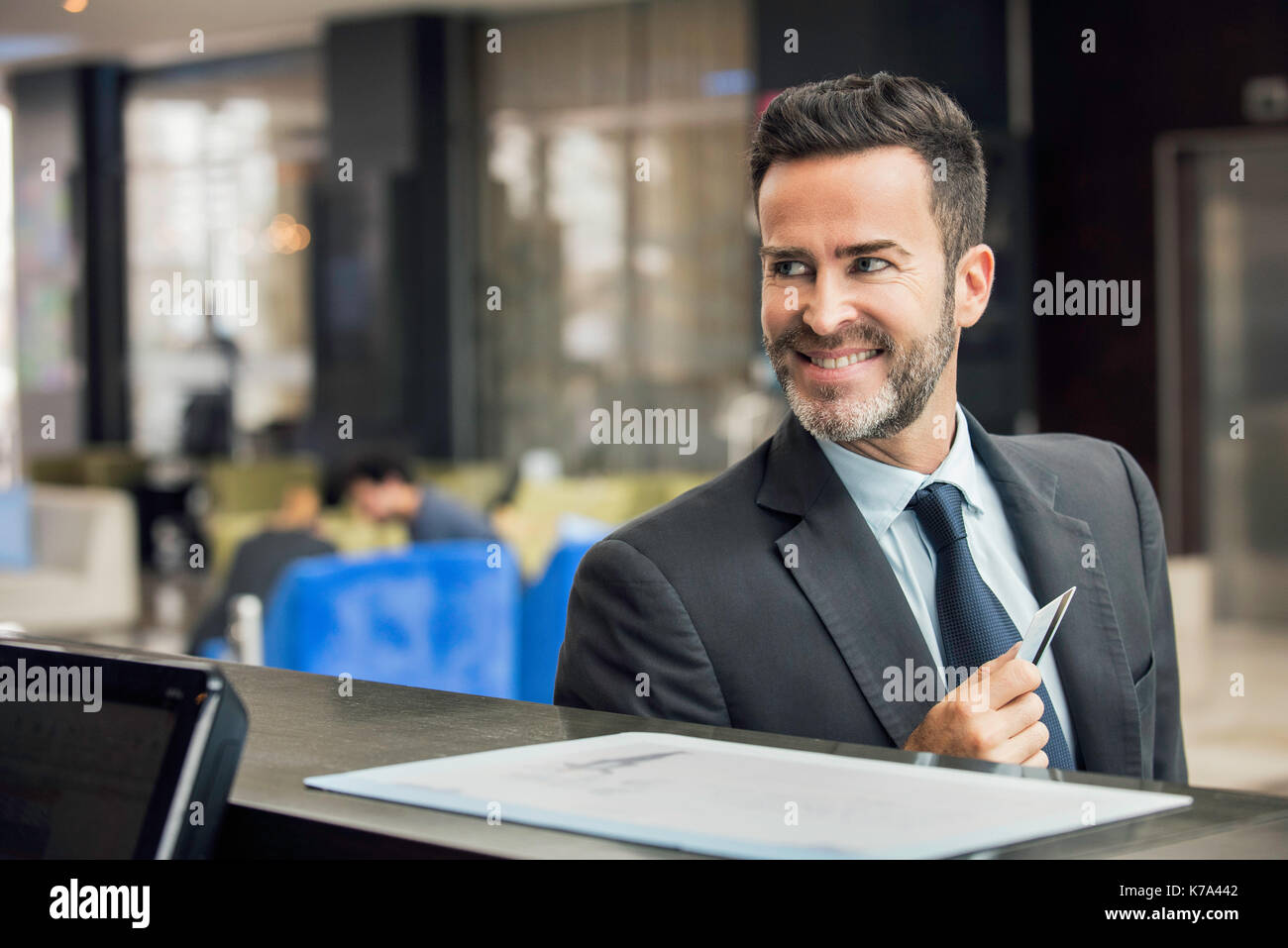 Business traveler at hotel reception Stock Photo - Alamy