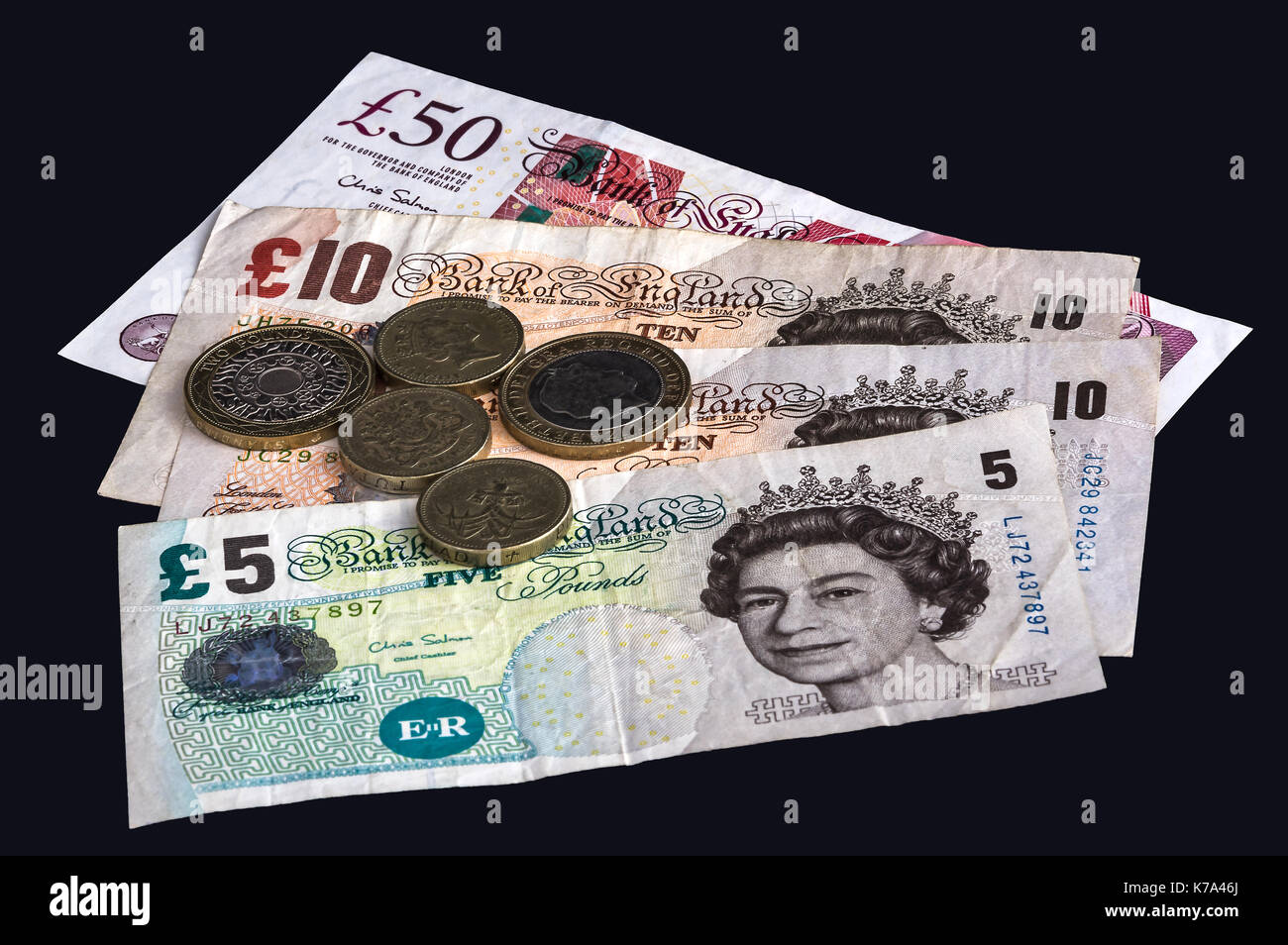 British banknotes and coins on a black background Stock Photo - Alamy