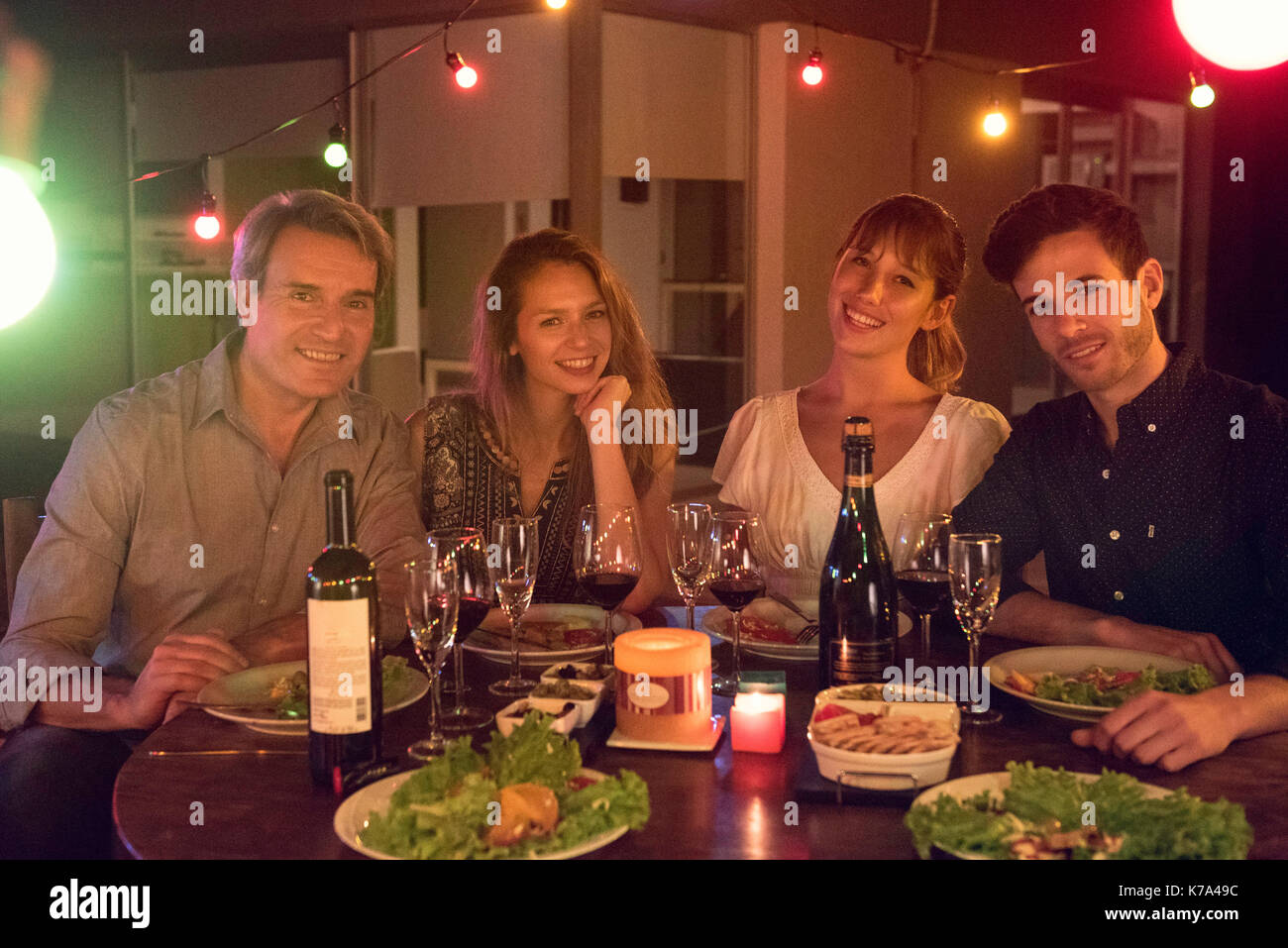 Group of adults at dinner table hi-res stock photography and images - Alamy