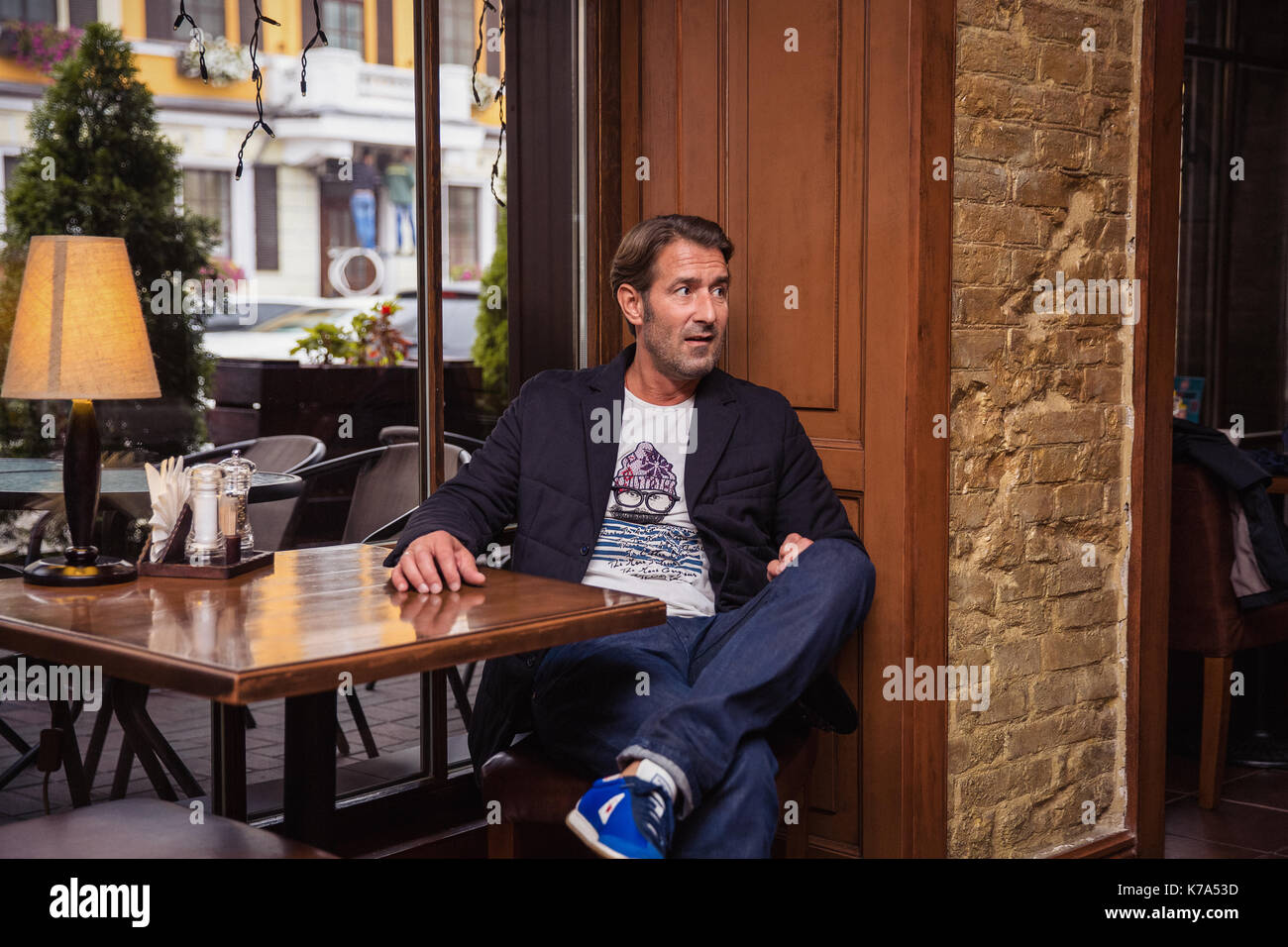 Man thinking by the bar window. Man waiting somebody Stock Photo - Alamy