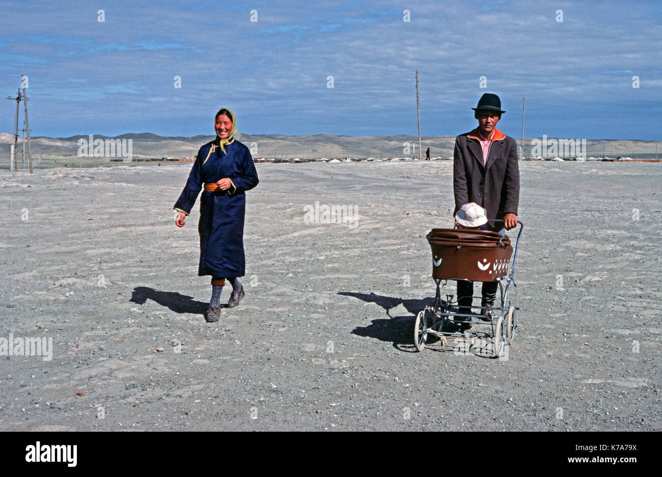 Mongolian couple and baby in pram walking in Gobi-Altai town, Gobi ...