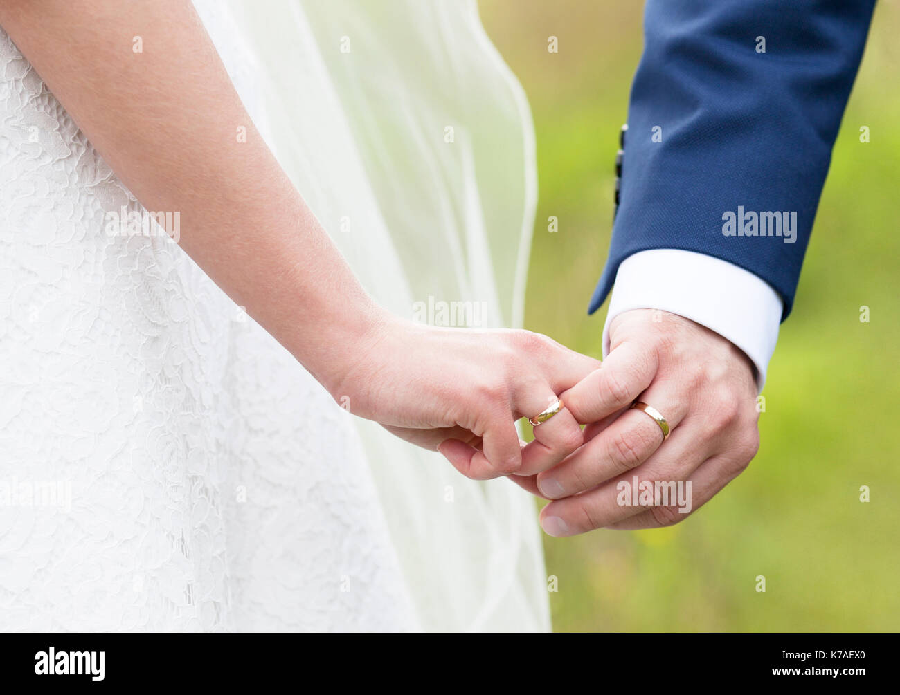 Wedding couple holding hands Stock Photo - Alamy