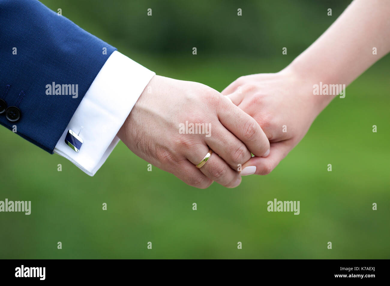 Wedding couple holding hands Stock Photo - Alamy