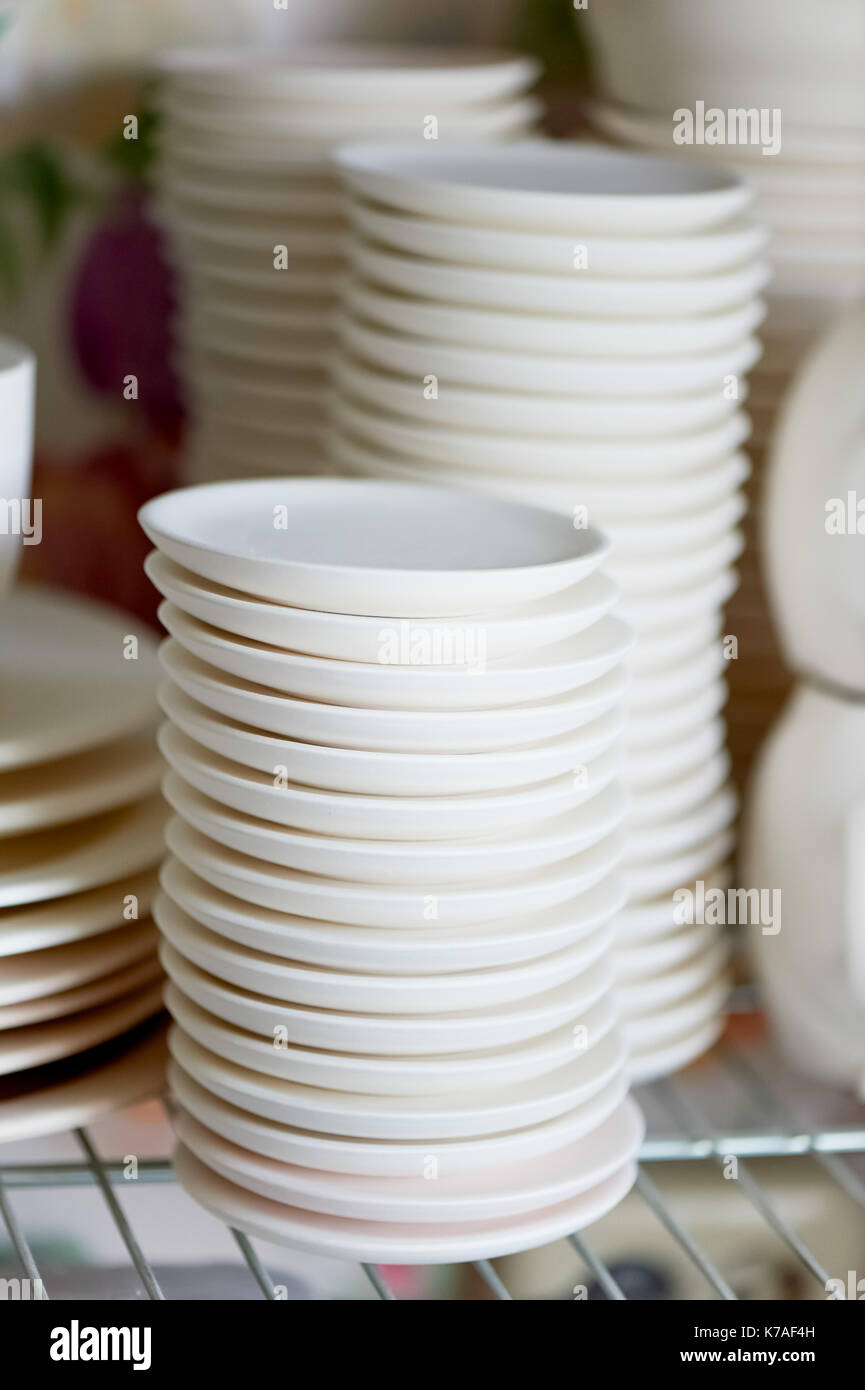 Set of white dishes isolated on white.Stack of plates Stock Photo - Alamy