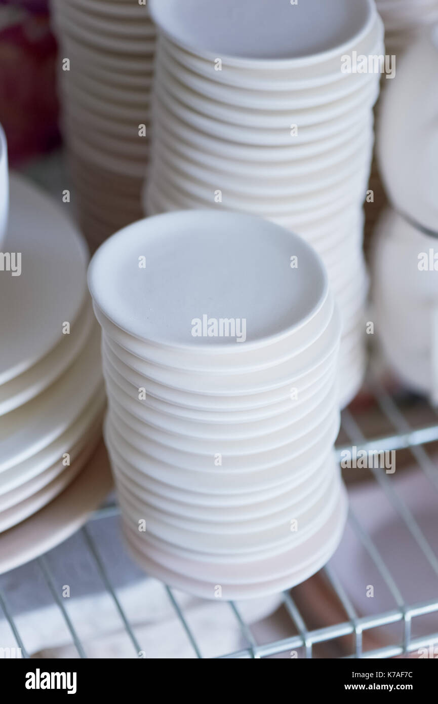 Set of white dishes isolated on white.Stack of plates Stock Photo - Alamy