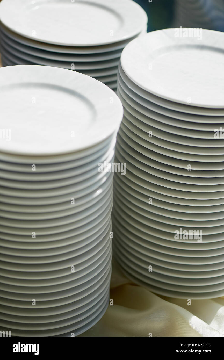 Set of white dishes isolated on white.Stack of plates Stock Photo - Alamy