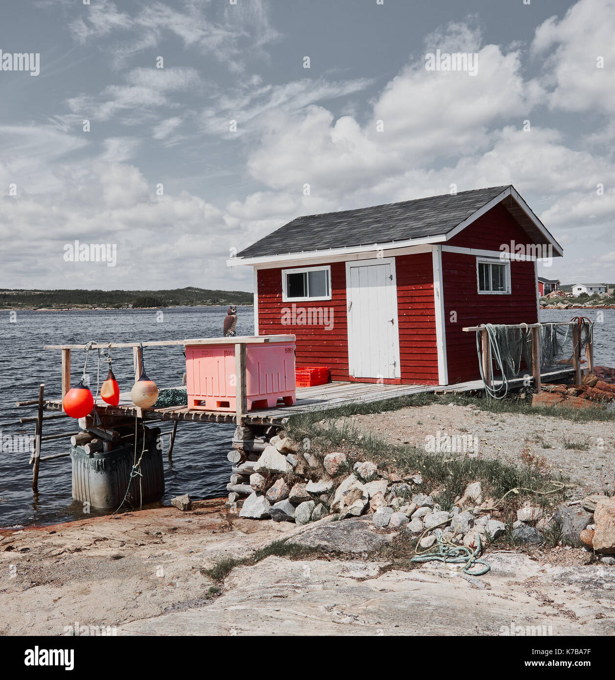 Rustic timber cabin above water with fishing equipment, Newfoundland ...