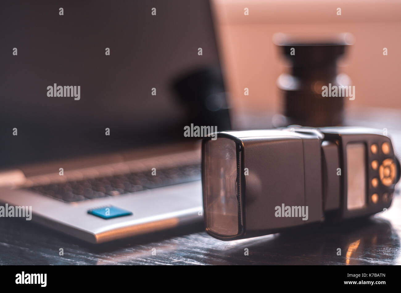 Table with photo equipment, computer, SD memory card, Flash and Lens ...