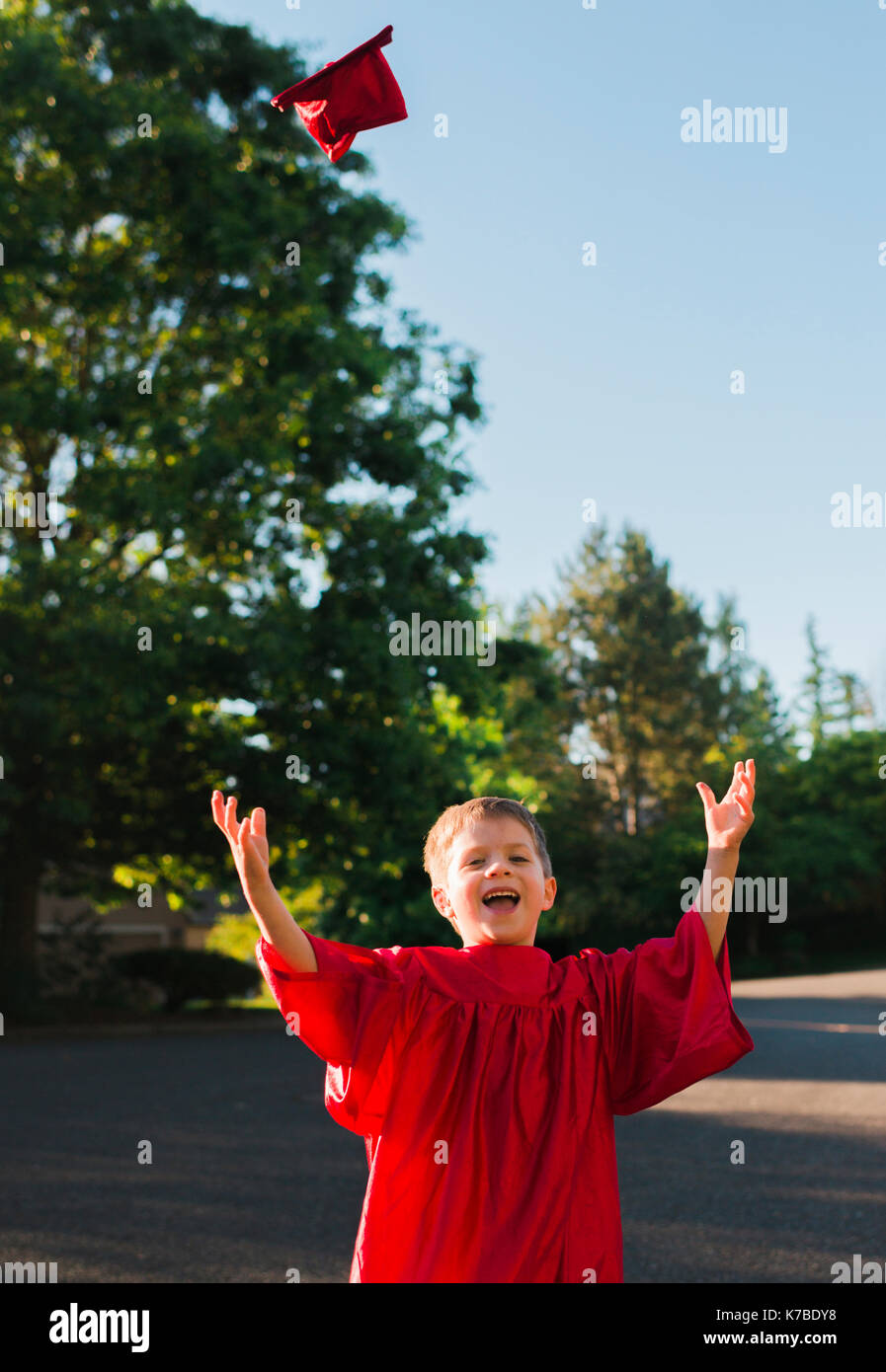 Boy in red graduation gown hi-res stock photography and images - Alamy