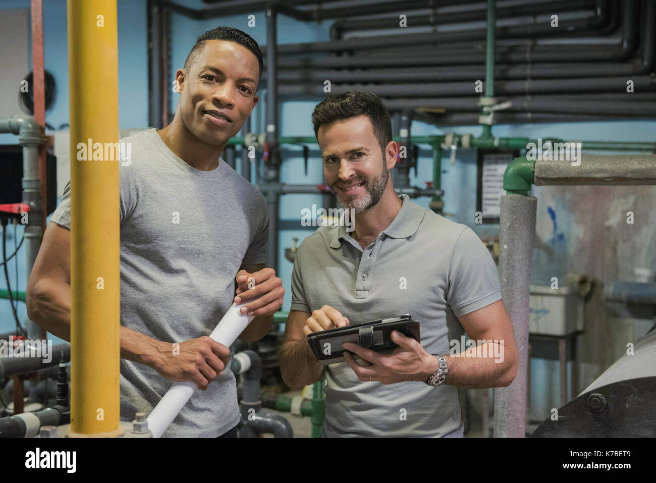 Men working in industrial setting, portrait Stock Photo - Alamy