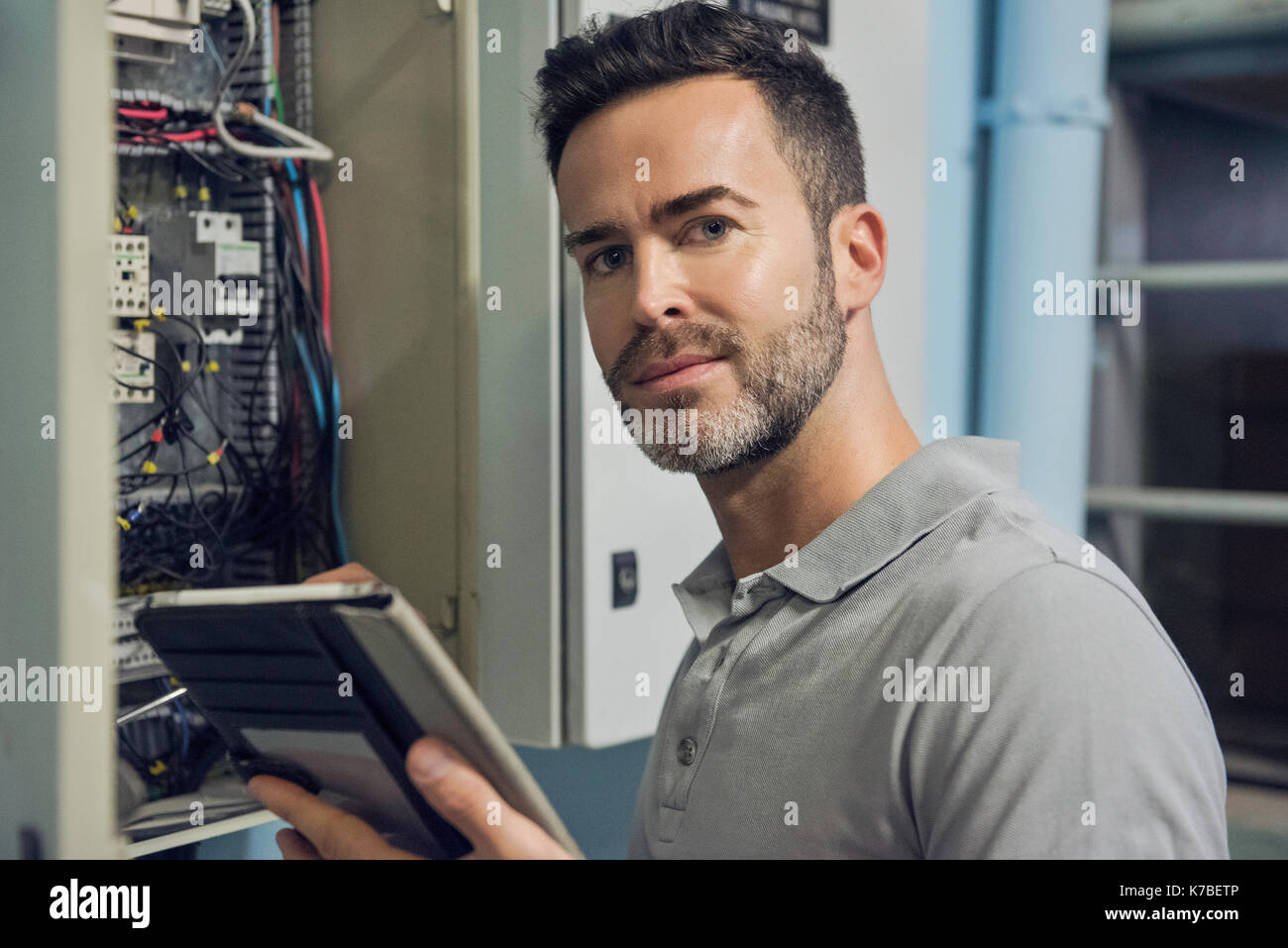 Man working in electrical control cabinet Stock Photo - Alamy