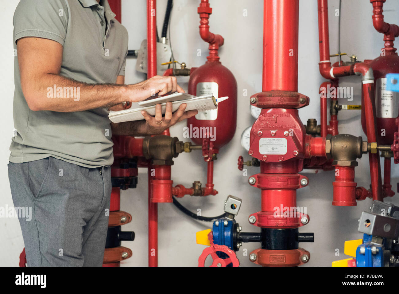 Man inspecting fire protection sprinkler system Stock Photo - Alamy