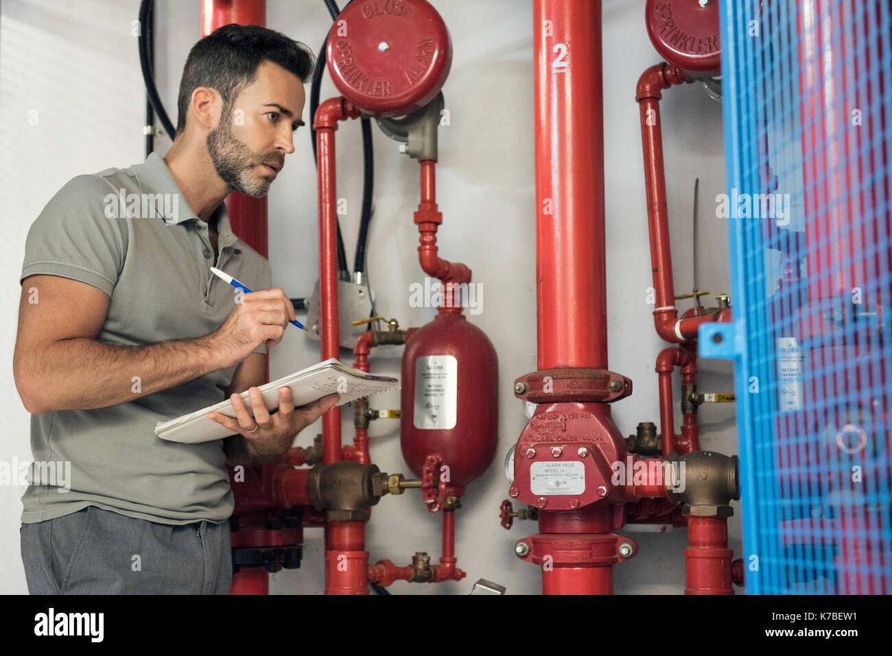 Man inspecting fire protection sprinkler system Stock Photo - Alamy