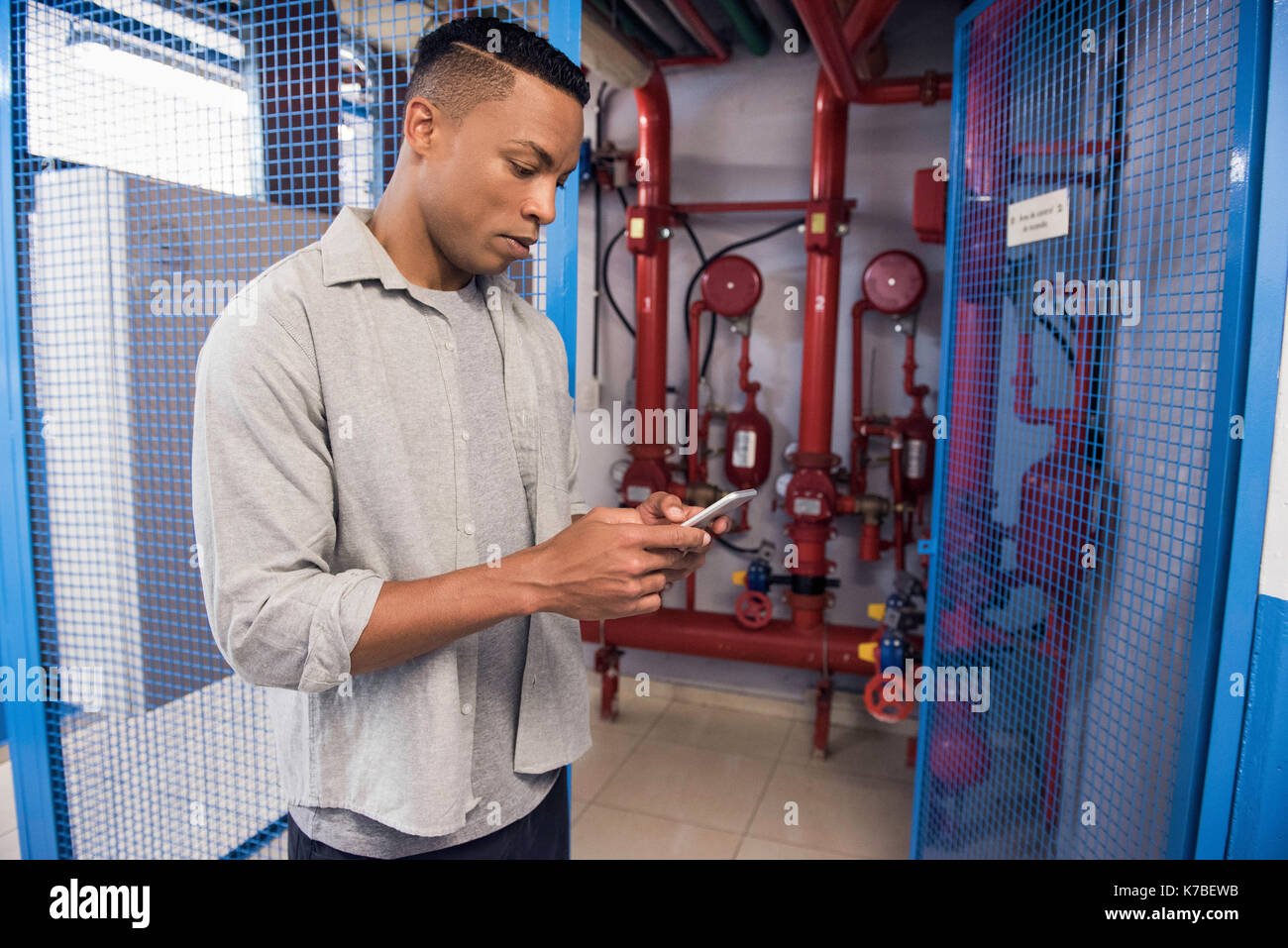 Man using mobile phone near fire protection sprinkler system Stock ...