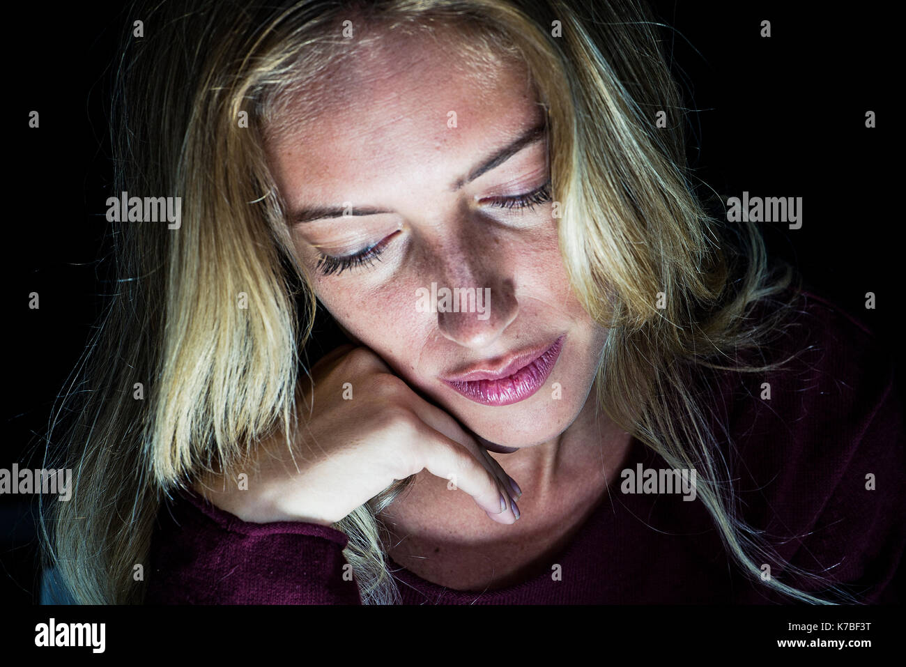 Young woman looking down sadly, portrait Stock Photo - Alamy