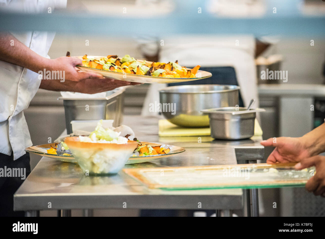 Chefs preparing food in commercial kitchen Stock Photo - Alamy