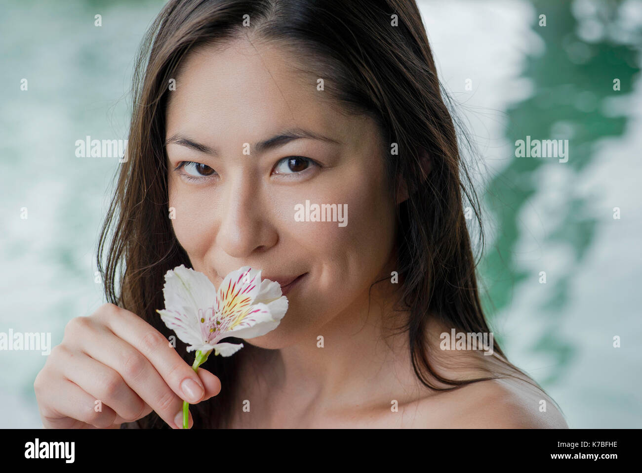 Woman smelling flower, portrait Stock Photo - Alamy