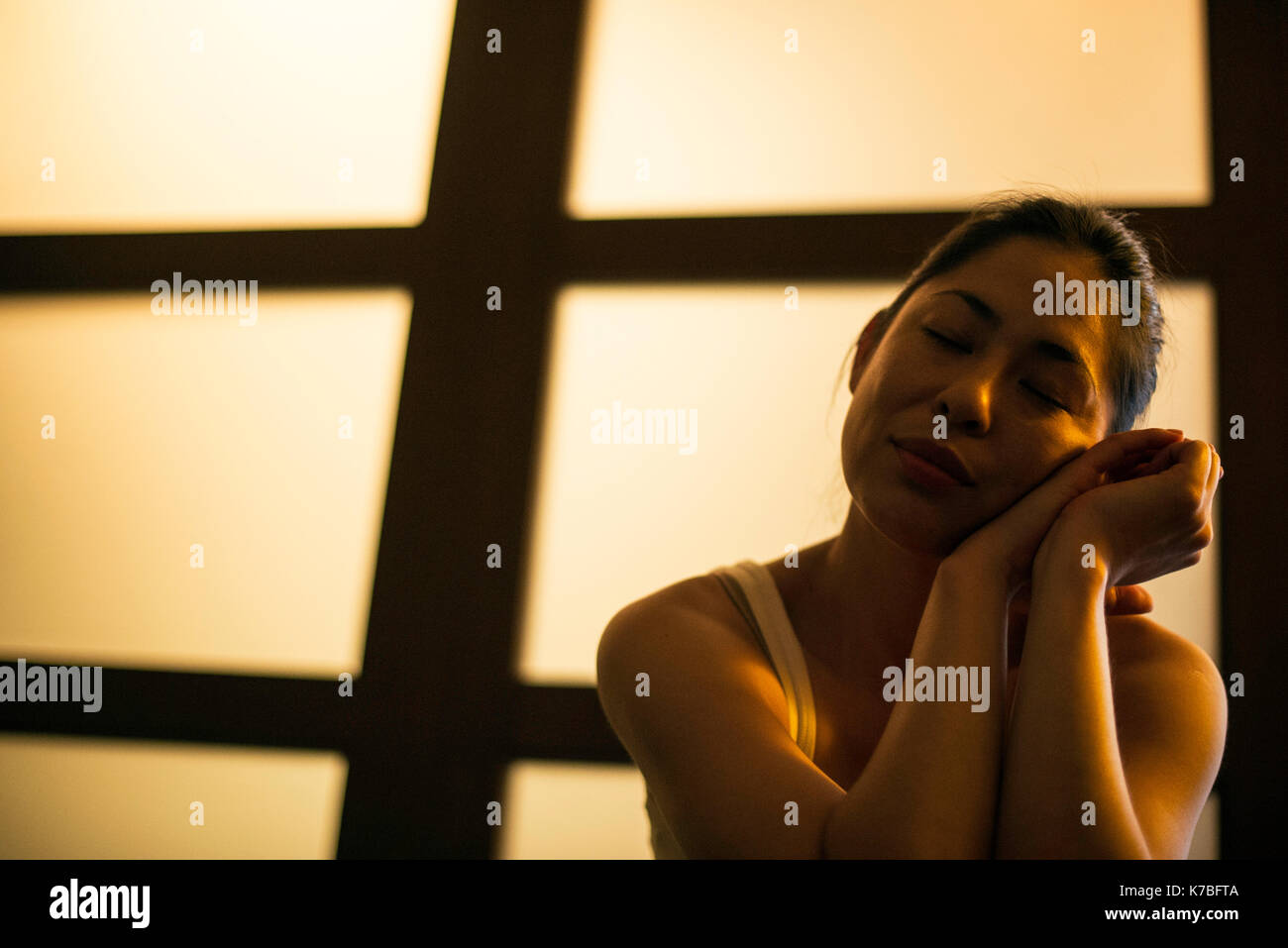Woman leaning on elbow with eyes closed Stock Photo - Alamy
