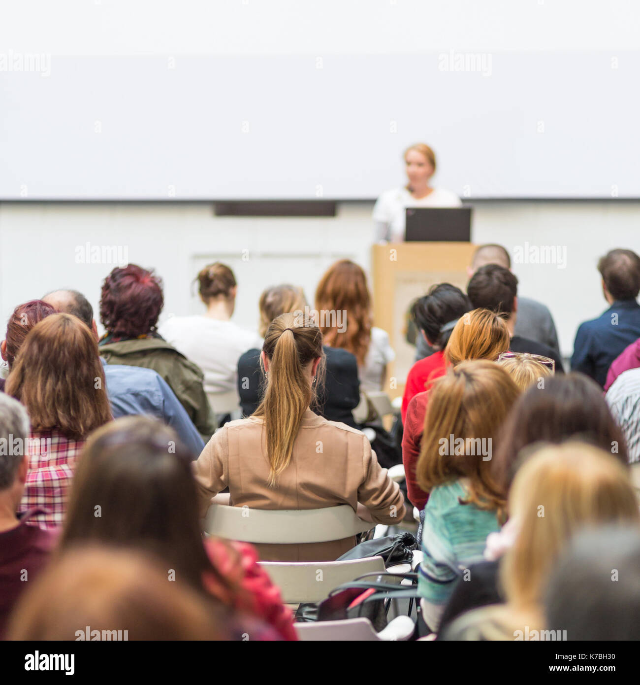 Woman giving presentation on business conference Stock Photo - Alamy