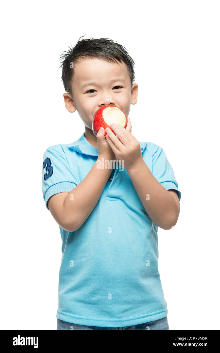Asian baby boy holding and eating red apple, isolated on white Stock ...