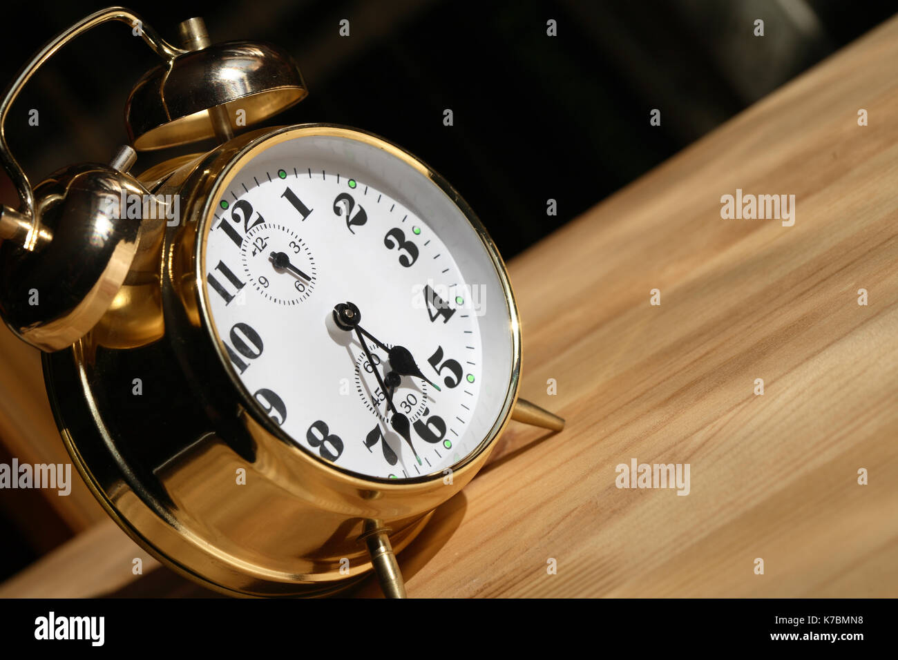Nice alarm clock closeup standing on wooden surface Stock Photo - Alamy