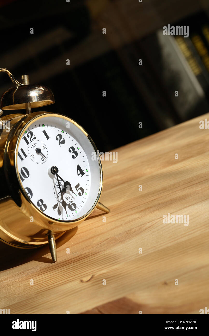 Nice alarm clock closeup standing on wooden surface Stock Photo - Alamy