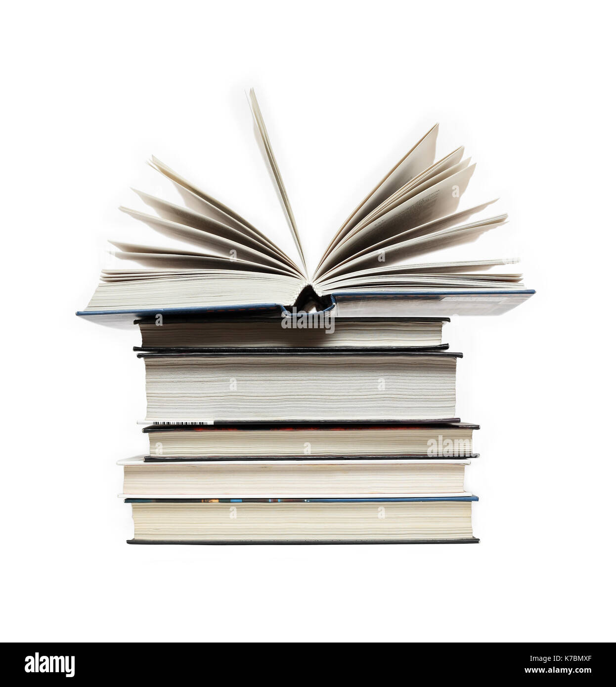 Open book lying on high stack of books on white background Stock Photo ...