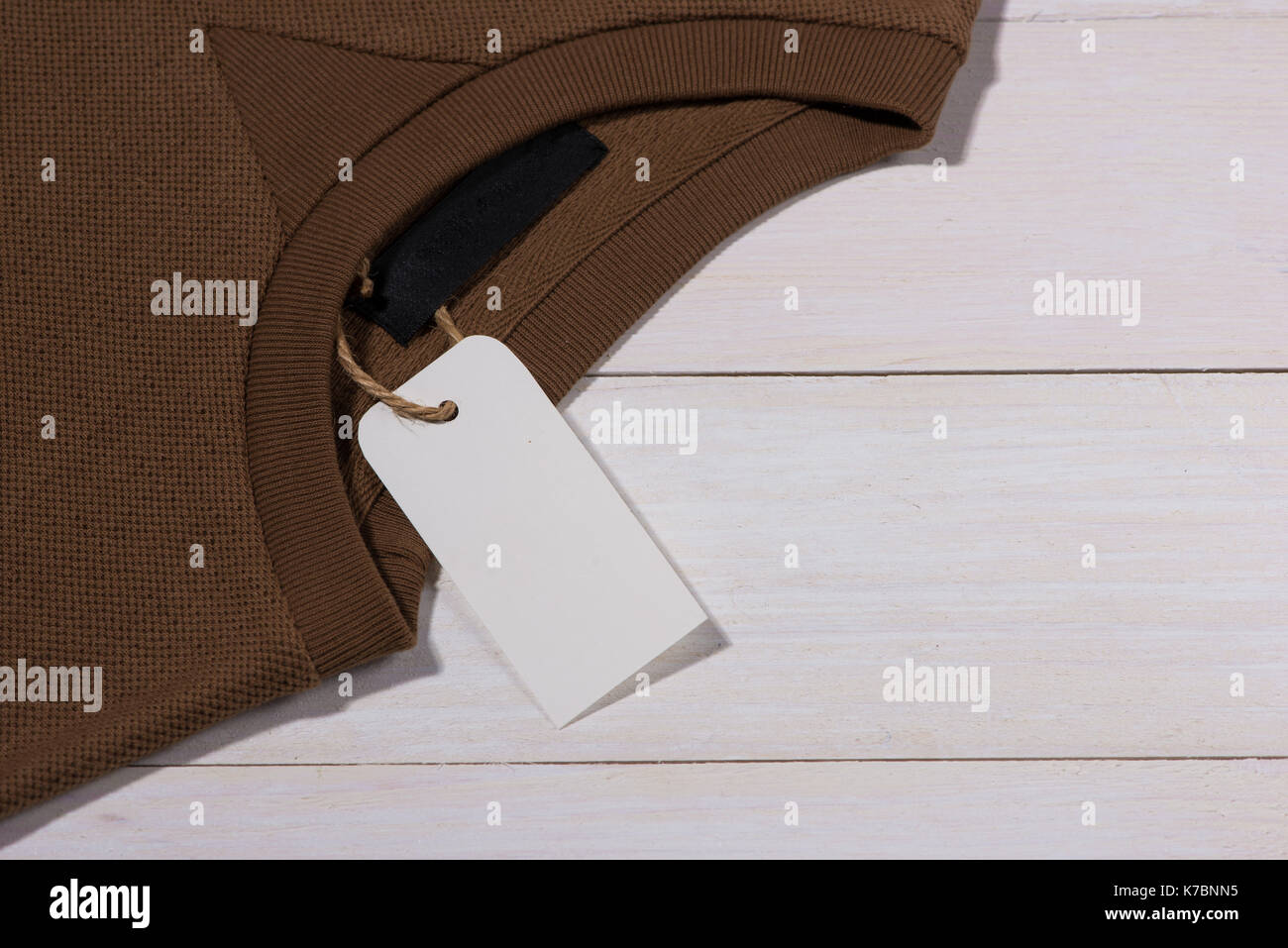 Shirt price tag. Rectangular tag is attached to a sweater Stock Photo ...