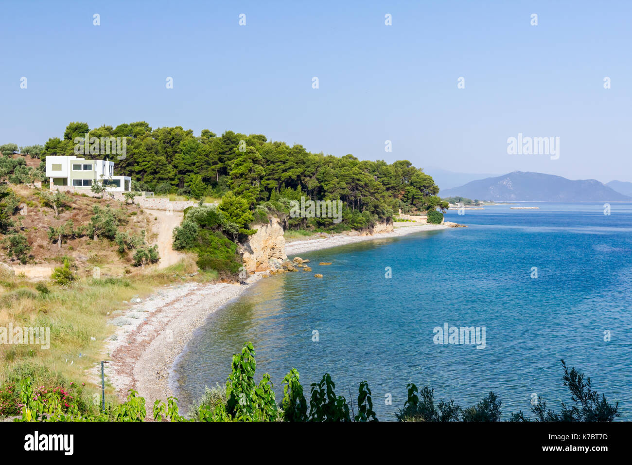 Luxury house is placed above rocky cliff in idyllic and peaceful bay ...