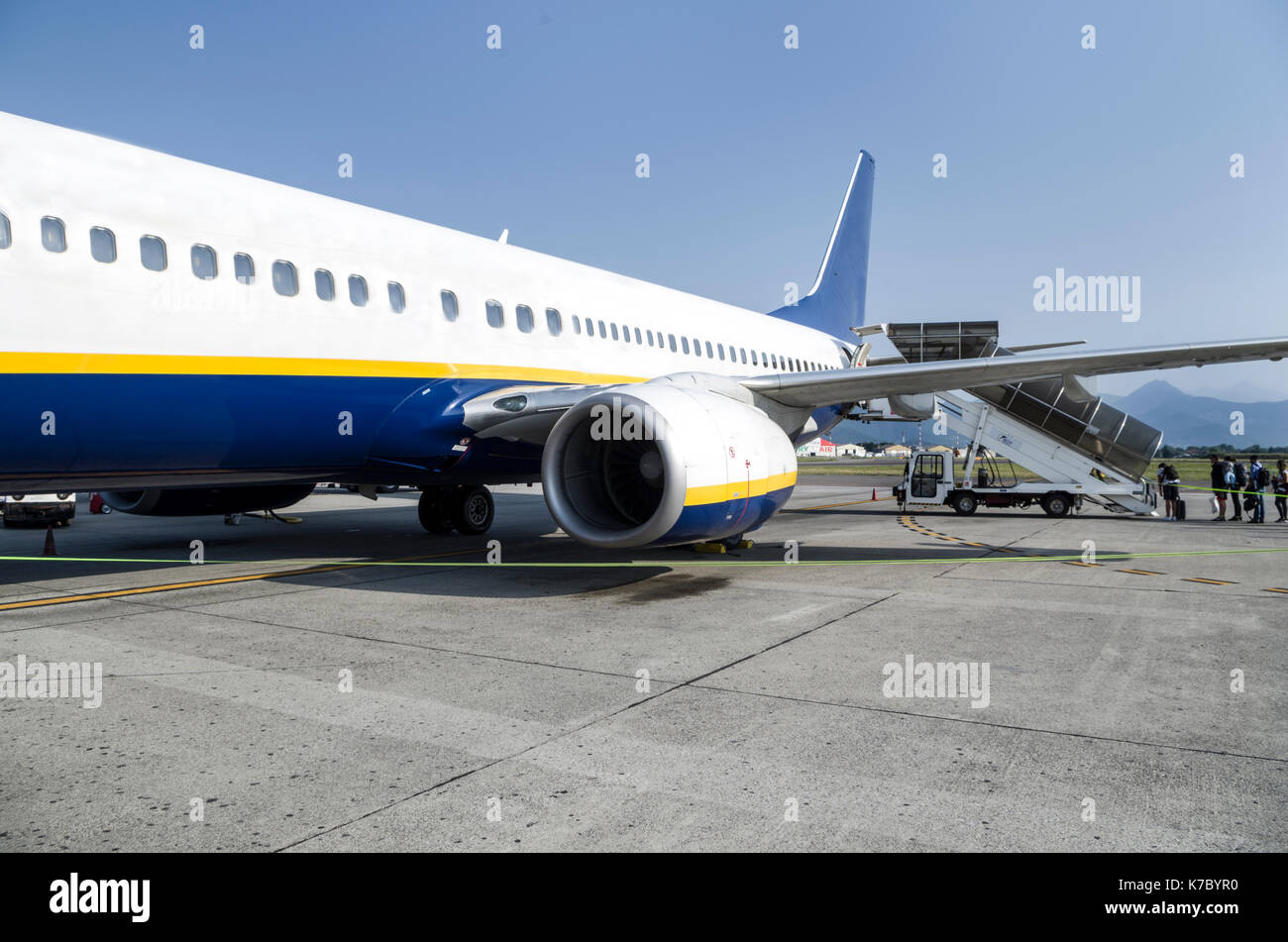 Passengers boarding on a plane in the morning. People waiting in queue ...