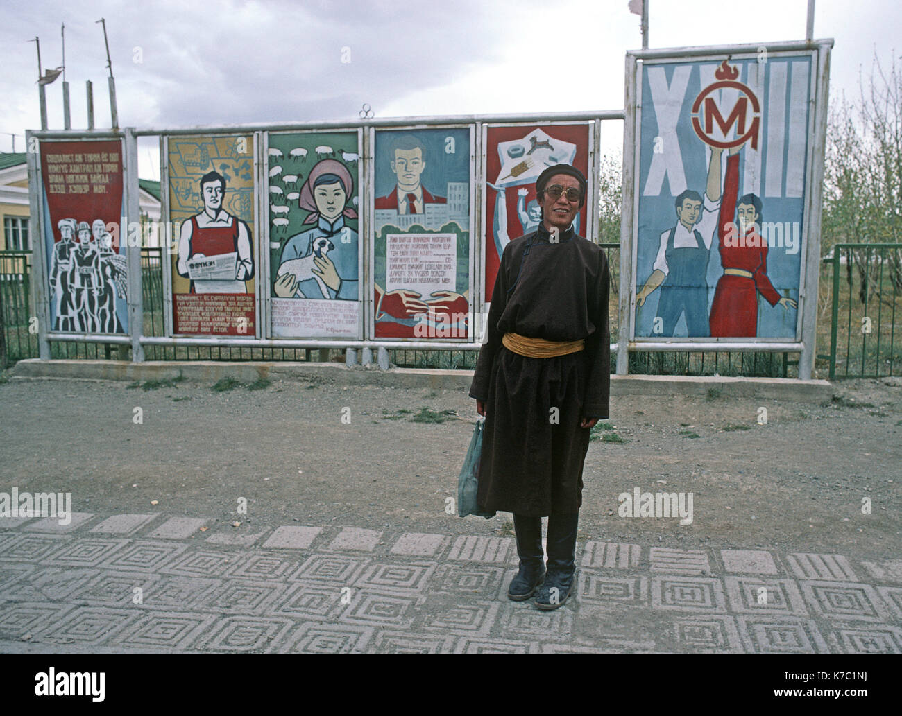 Mongolian in front of Mongolian propaganda posters, Gobi-Altai town ...