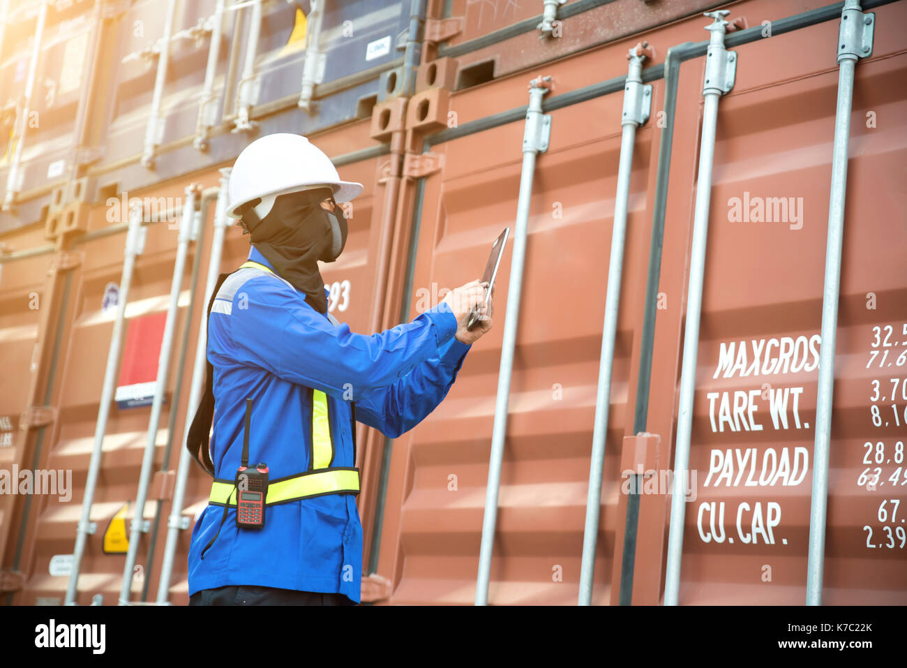 Foreman control loading Containers box from Cargo freight ship for ...