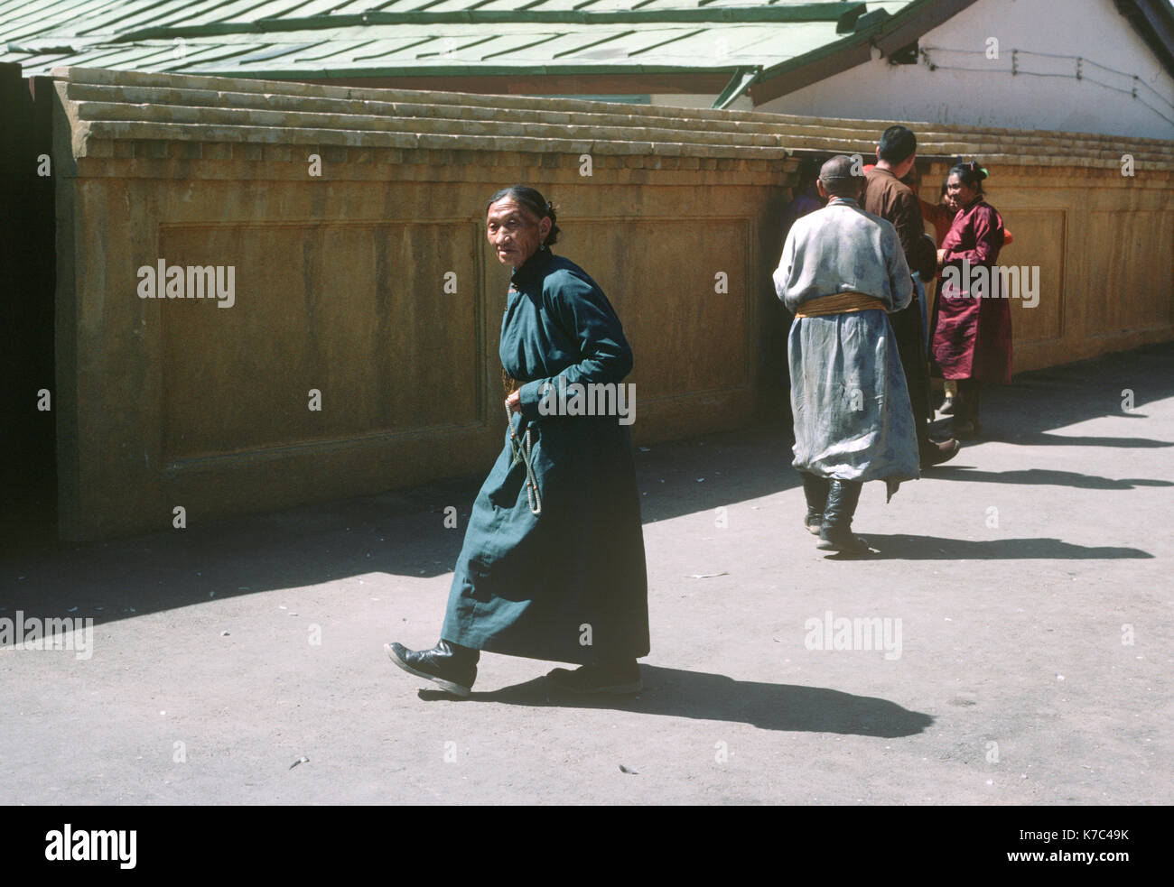 Mongolians outside Buddhist Temple walls, Ulan Bator, Mongolia, Asia ...