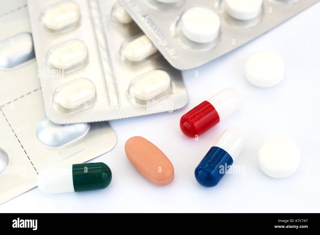 Colored capsules, pills medicines and blister photographed on a white ...