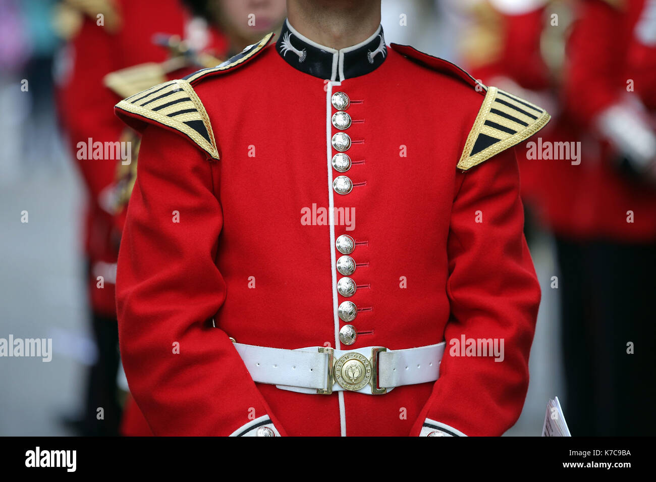 Pictured: The bright red tunic worn by a Welsh Guard as he parades ...