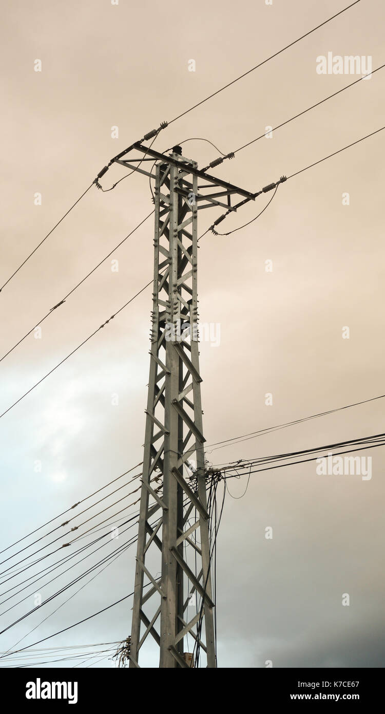 Electricity pillar against a colorful yellow sunset in southern Vietnam ...