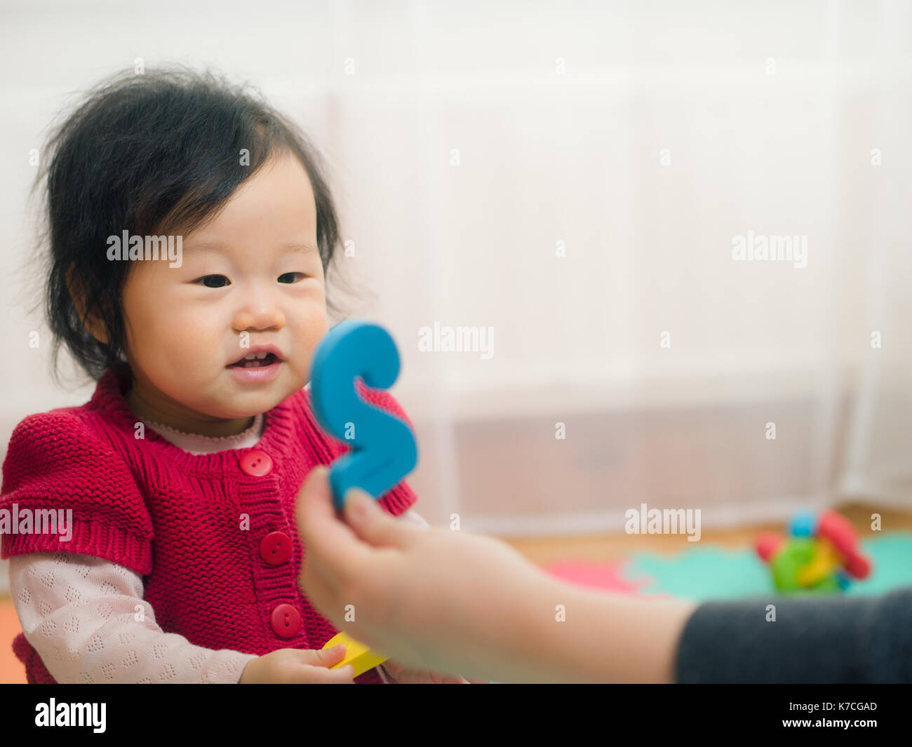 baby girl learning letters Stock Photo - Alamy