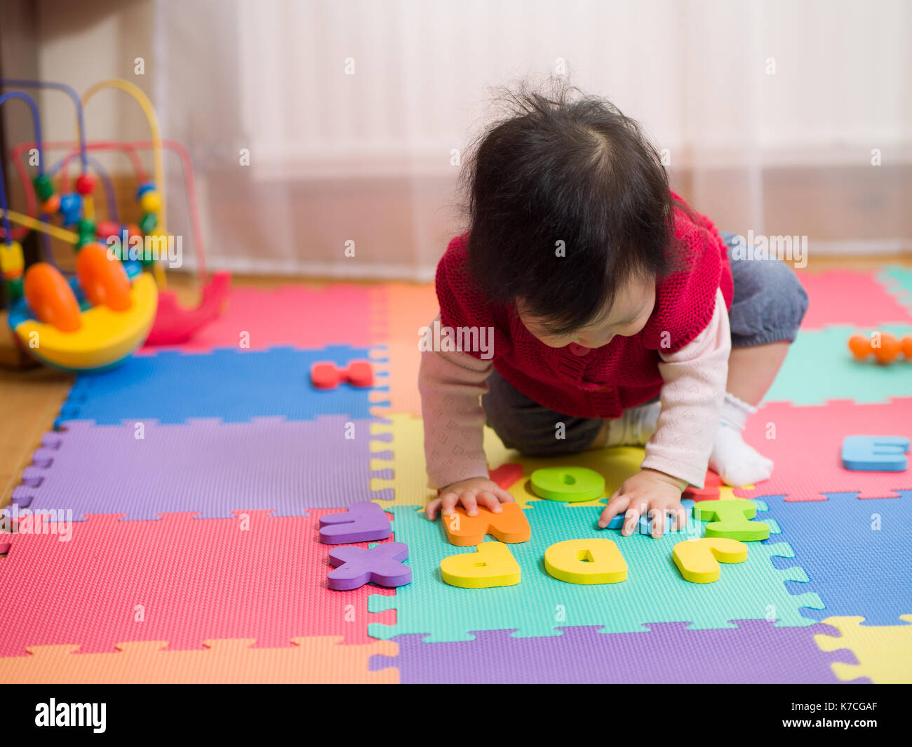 baby girl learning letters Stock Photo - Alamy