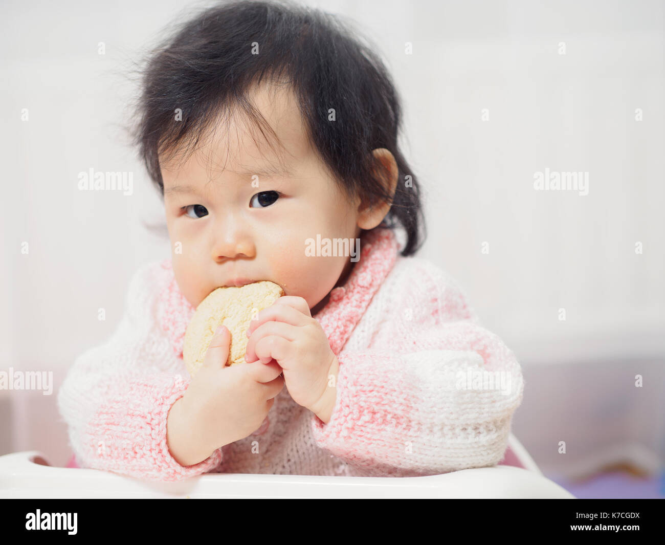 baby girl snacking time Stock Photo - Alamy