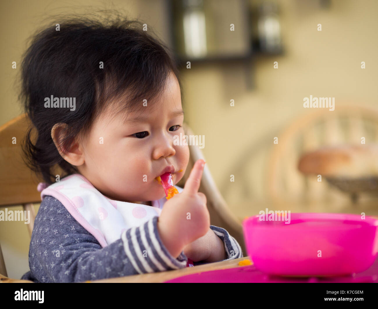 baby girl eating mashed sweet potatoes Stock Photo - Alamy