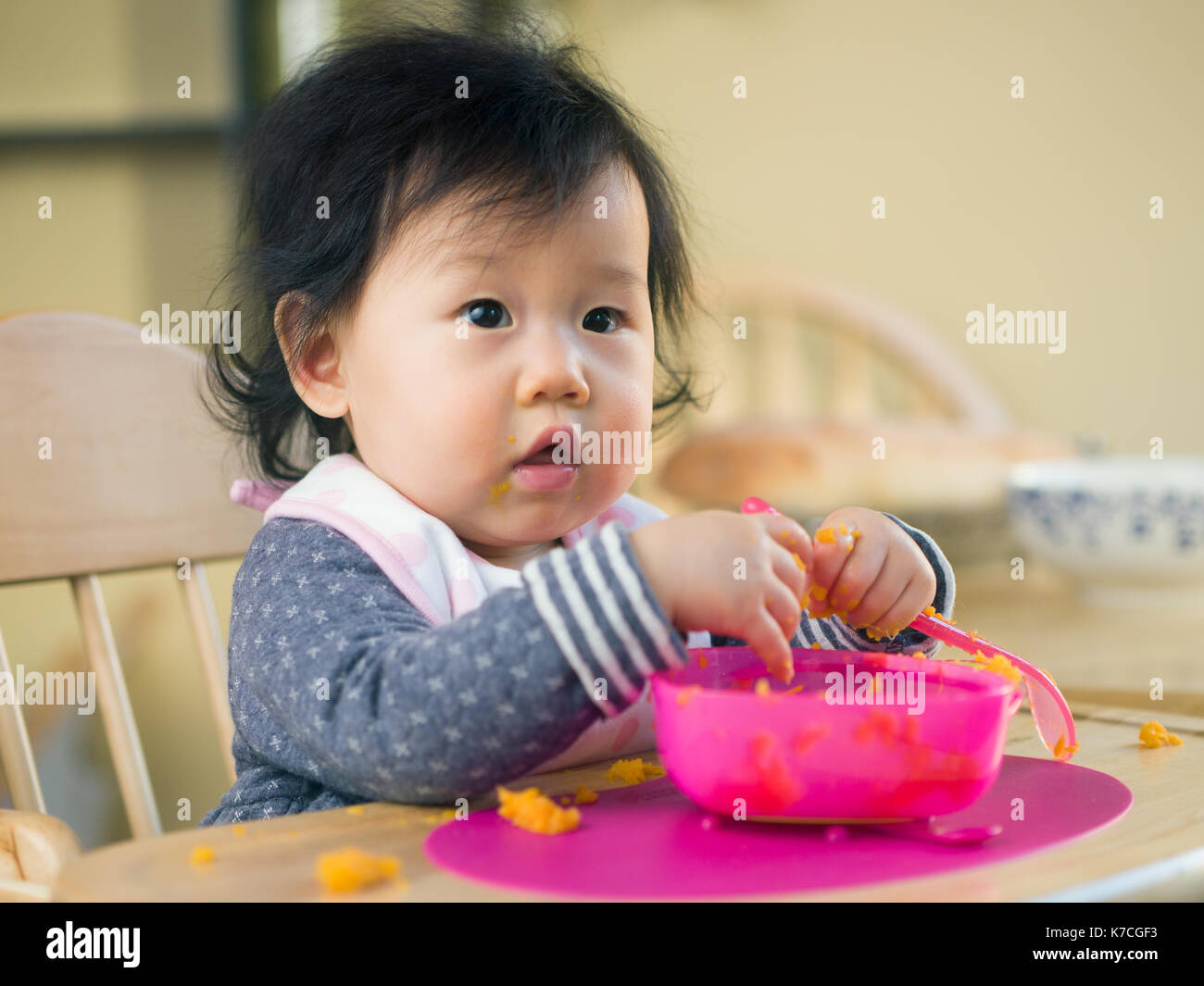 baby eating mashed sweet potato Stock Photo - Alamy