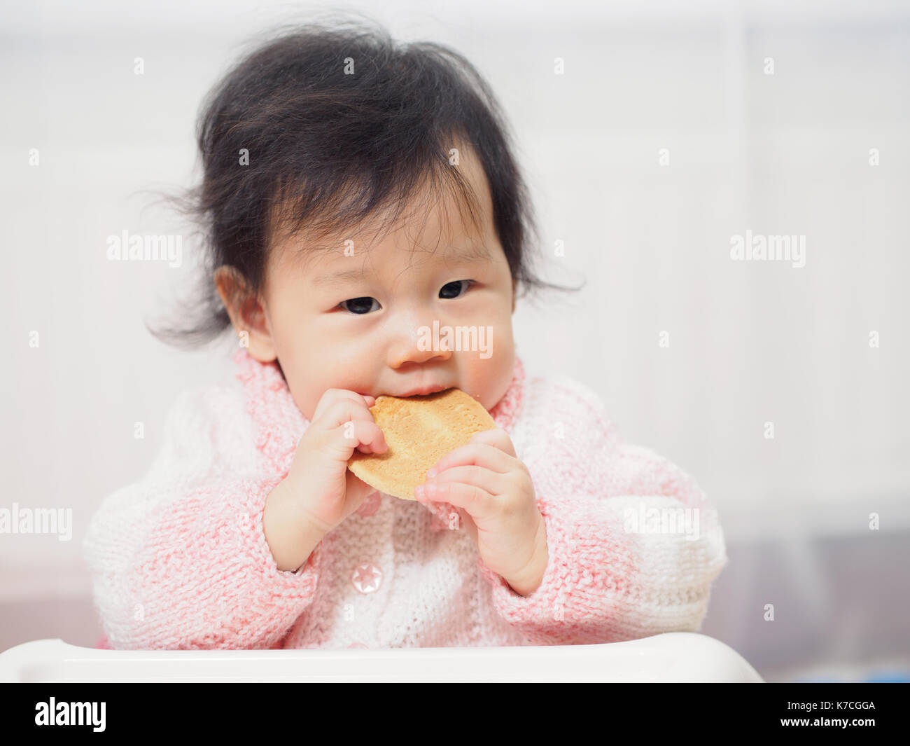 baby girl snacking time Stock Photo - Alamy